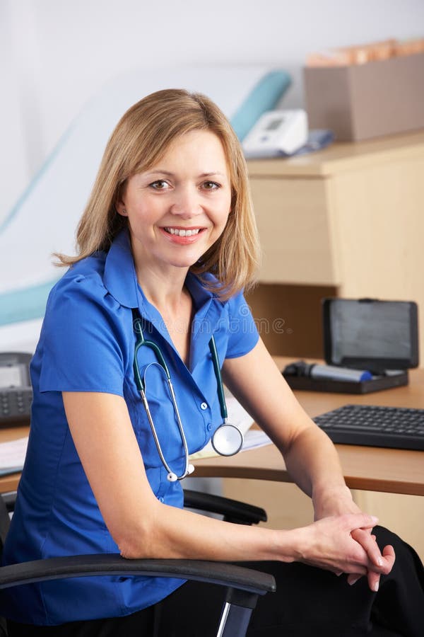 Doctor Sitting By Female Patient S Bed In Hospital Stock Image - Image ...