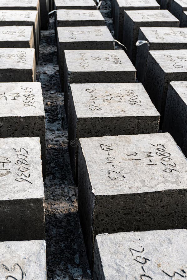 Granite Bolder in Infront of River. a Pile of Four Square Cinder Blocks ...