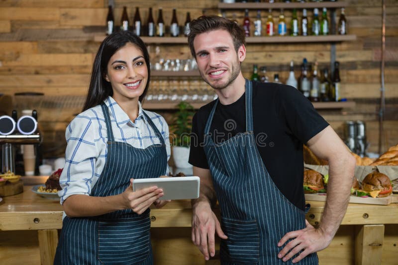 Portrait of Waiter and Waitresses Using Digital Tablet at Counter Stock ...