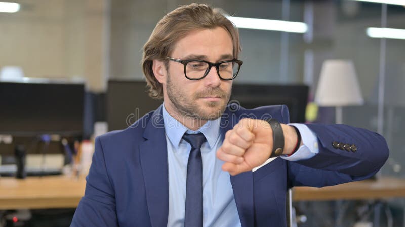 Portrait of Waiting Businessman Checking Time on Watch Stock Photo ...