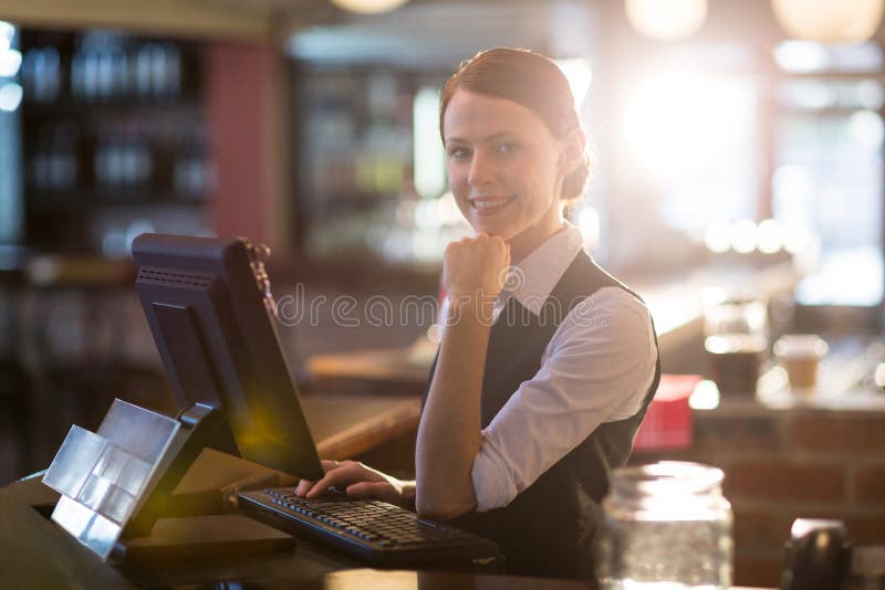 Portrait of Waitress Using a Computer at Counter Stock Photo - Image of ...