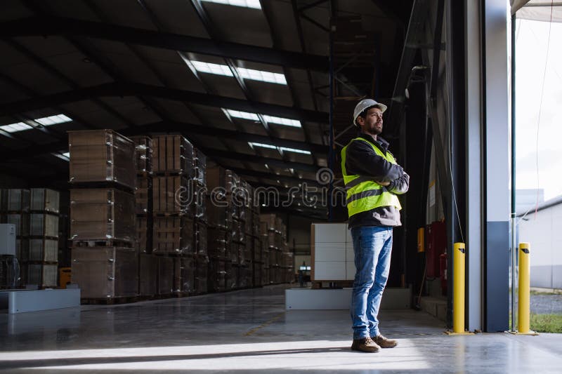 Portrait of Warehouse Worker Taking Break from Work, Standing and ...