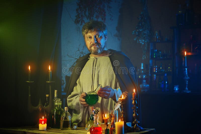 Wizard with Burning Candles and Magic Potions Stock Photo - Image of ...