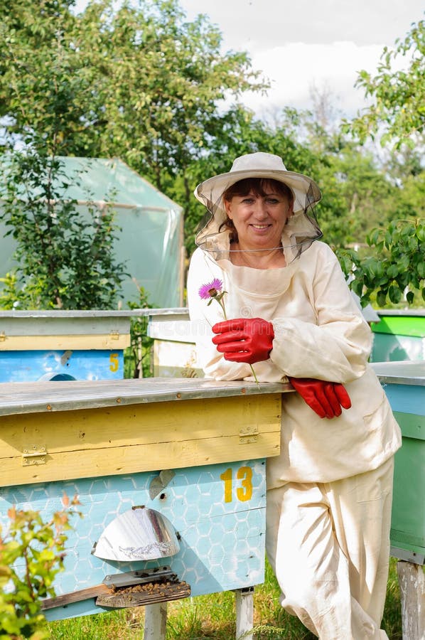 Portrait of a Woman Beekeeper with Flower Stock Photo - Image of ...