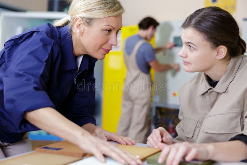 Portrait Woman Helping Young Apprentice Stock Image - Image of trainer ...