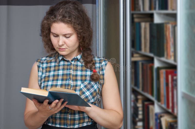 Portrait of Woman Reading a Book in Front of a Bookcase Stock Image ...