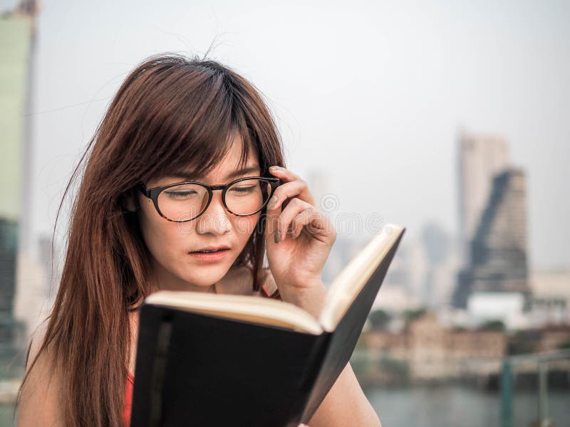 Portrait of a Woman Reading a Book with Glasses Stock Photo - Image of ...