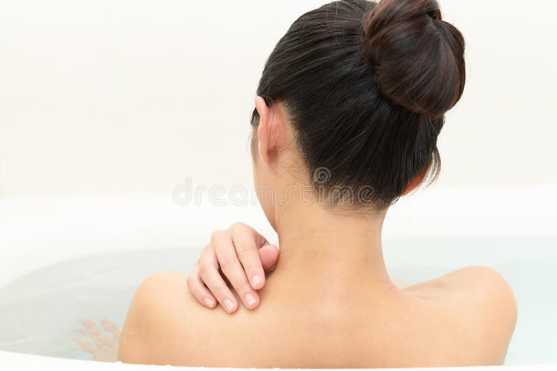 Woman taking relaxing bath stock image. Image of bathroom - 134362109