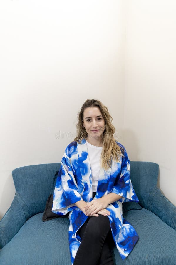 Portrait of a Woman Smiling while Sitting on a Sofa. Stock Photo ...