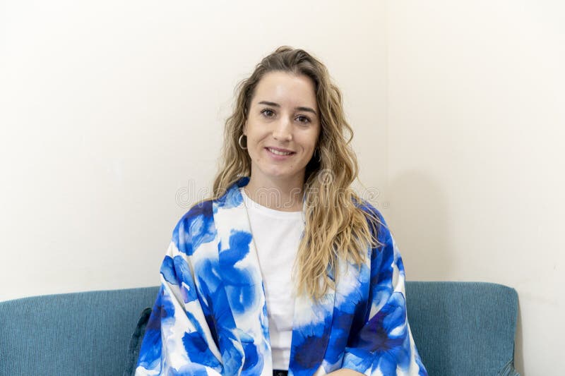 Portrait of a Woman Smiling while Sitting on a Sofa. Stock Image ...