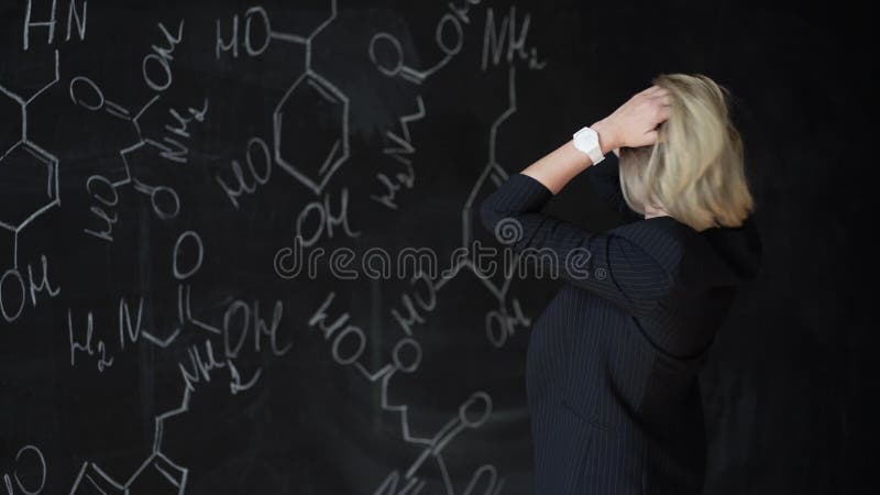 Portrait of a Woman Solving a Difficult Task, Standing Near the Board ...