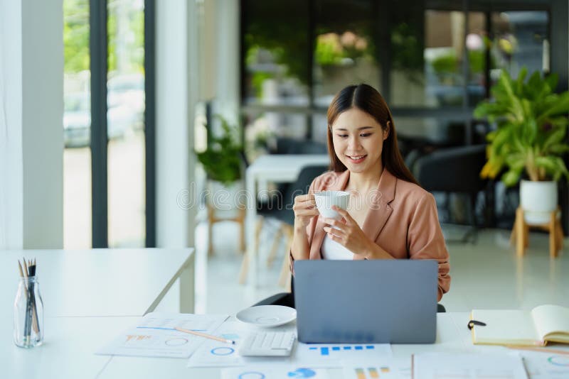 Portrait of a Woman Taking a Coffee Break while Using a Computer. Stock ...