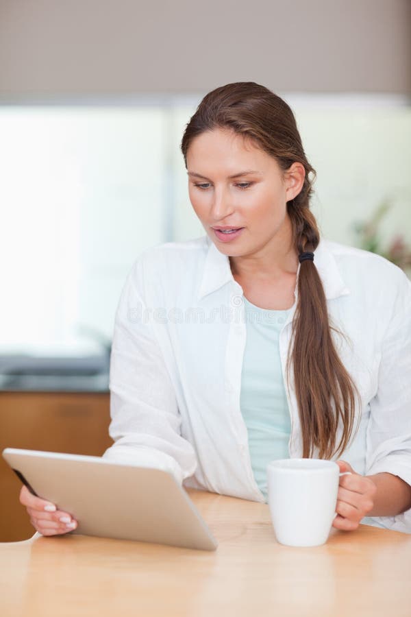 Portrait of a Woman Using a Tablet Computer while Drinking Tea Stock ...