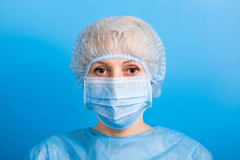 Portrait Of Woman Wearing Medical Mask With Epidemic Word At Blue