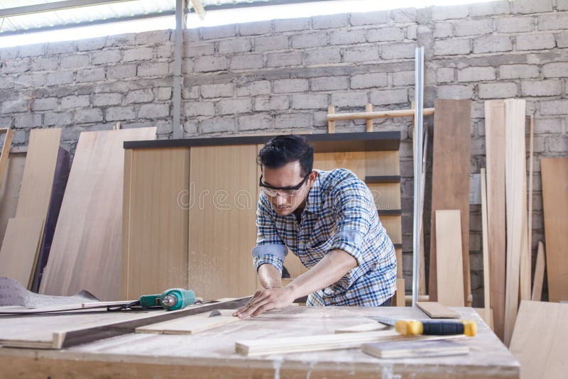 Worker at Carpenter Workspace Cutting the Wood Board Using Saw T Stock ...