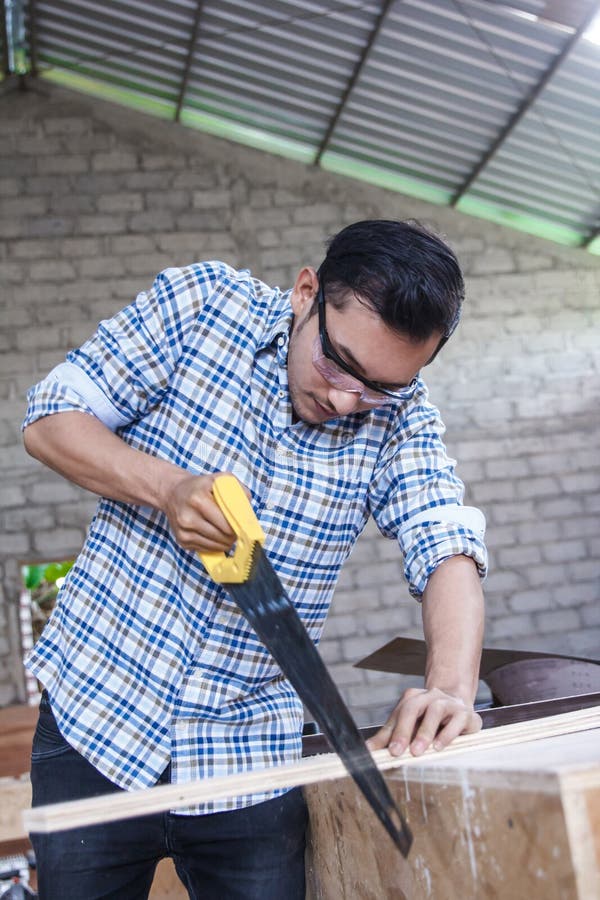 Worker Cutting the Wood Board Using Saw Stock Photo - Image of ...