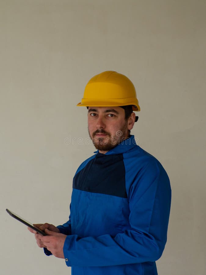 Portrait of Worker or Engineer in Blue Work Clothes and Yellow Safety ...