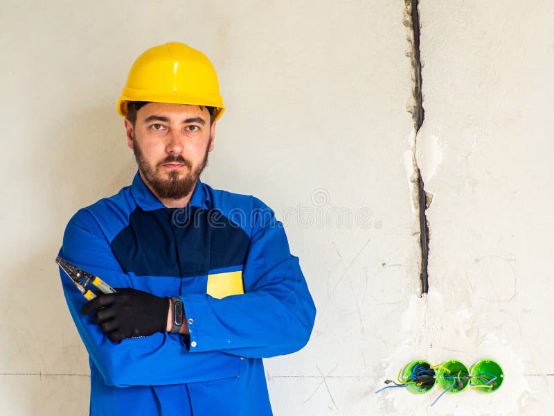 Portrait of Worker or Engineer in Blue Work Clothes and Yellow Safety ...