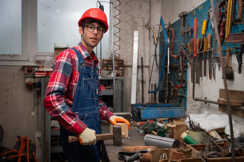 Portrait of a Worker in a Factory with Working Tools in the Workbench ...