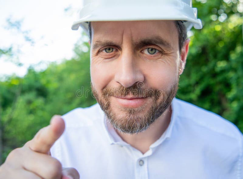 Portrait of Worker Man in Hardhat Pointing Finger Outdoors Stock Photo ...