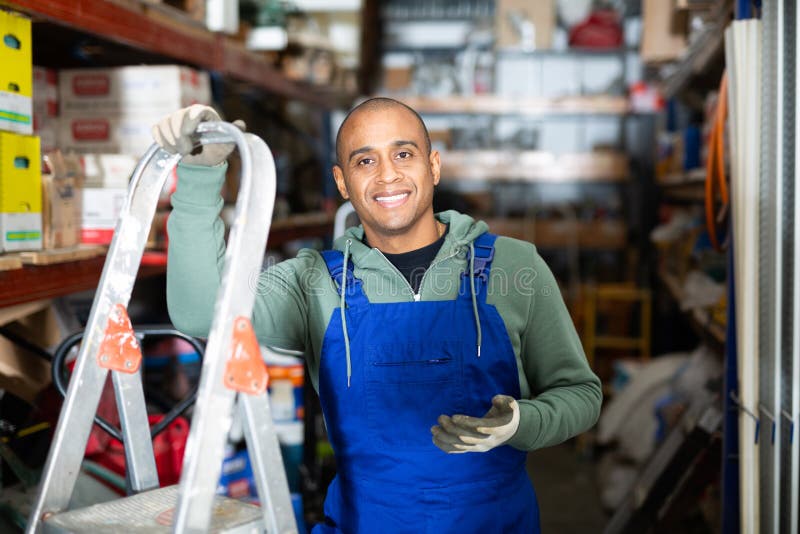 Portrait of a Worker in Overalls at the Warehouse of Hardware Store ...