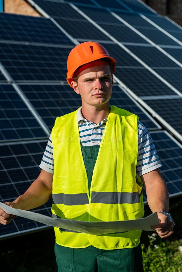 Portrait of Worker in Protective Uniform Standing before Solar Panels ...