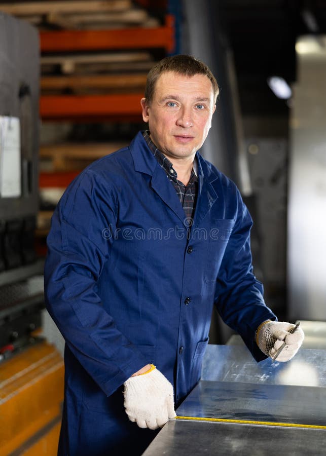 Portrait of Worker with Tape Measure Who Measures Sheet of Iron Using ...