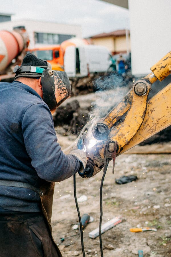 Worker Using Arc Welding Machine for Working on Construction Site Stock ...