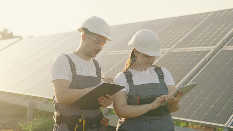 Portrait of Workers in Front of Solar Panels Discussing Information ...