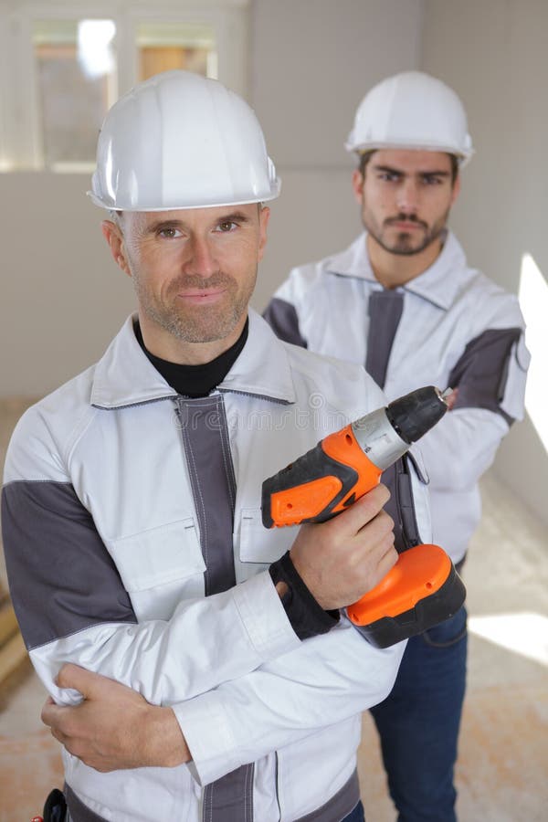 Portrait Workmen Holding Power Tool Stock Image - Image of strong, team ...