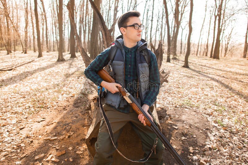 Portrait of Yang Hunter with a Backpack and a Gun on the Forest Stock ...