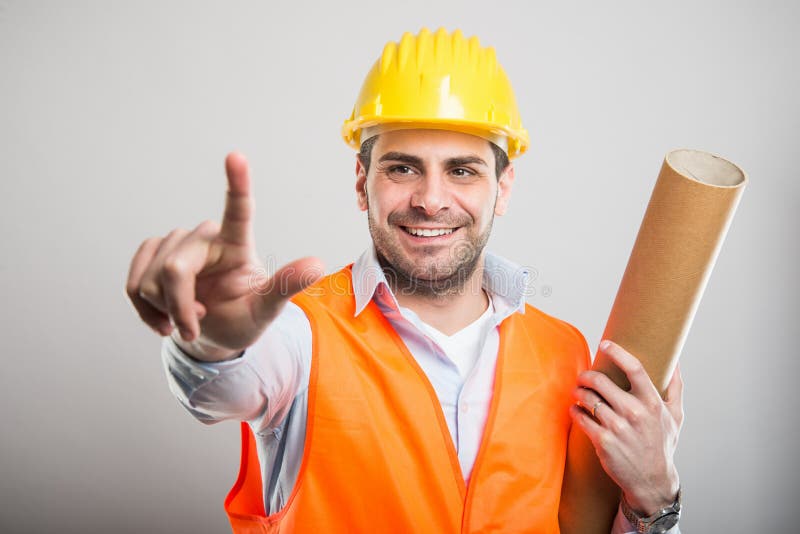 Portrait of Young Architect Holding Blueprints Showing Two Fingers ... Portrait of Young Architect Holding Blueprints Showing Two Fingers ...