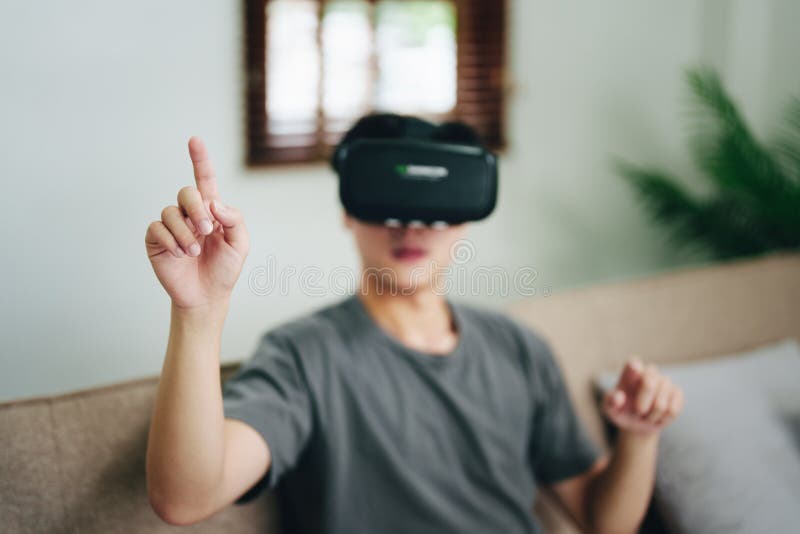 Portrait of a Young Asian Man Using Virtual Reality Simulator Headset ...