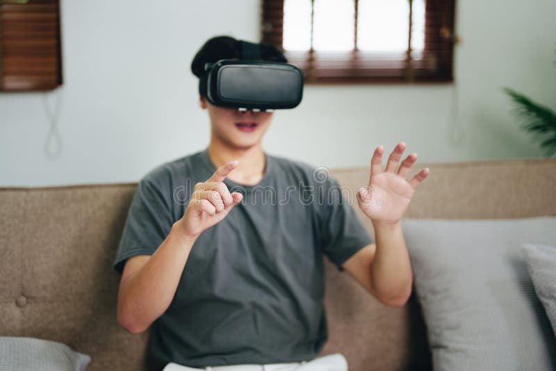 Portrait of a Young Asian Man Using Virtual Reality Simulator Headset ...