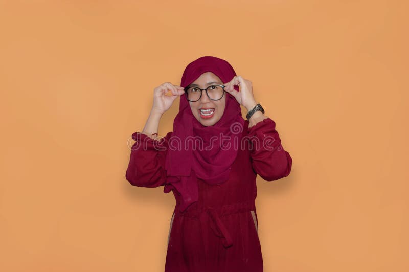Young Asian Muslim Woman Wearing Hijab And Eyeglasses Looking To The