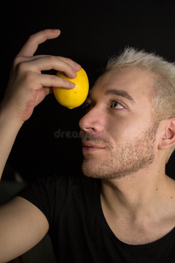 A Portrait of a Young Bearded Man. a Man Holding Lemon by His Face ...