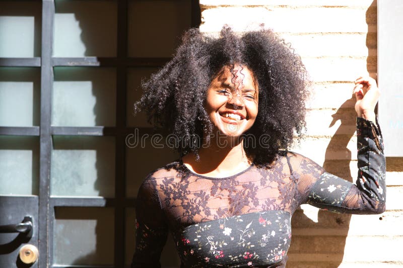 Young Beautiful Black Woman With Afro Hair Dressed In Casual Clothes