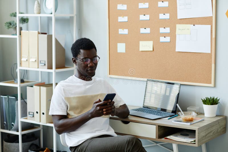 Young Man Using Smartphone at Work Stock Image - Image of black, career ...