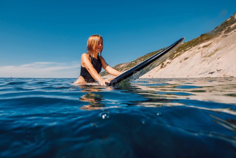 Blonde Surf Girl Riding On Surfboard In Ocean During Surfing Surfer On