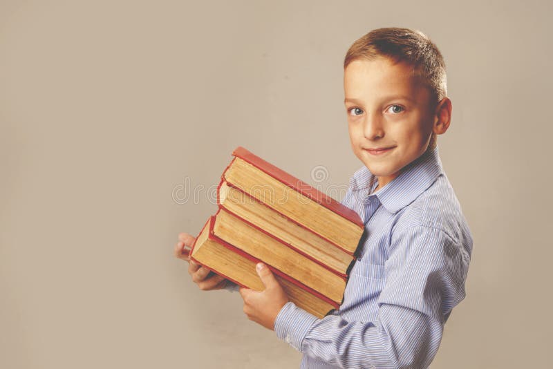 Portrait of Young Boy of School Age with Pile of Books As Symbol of ...