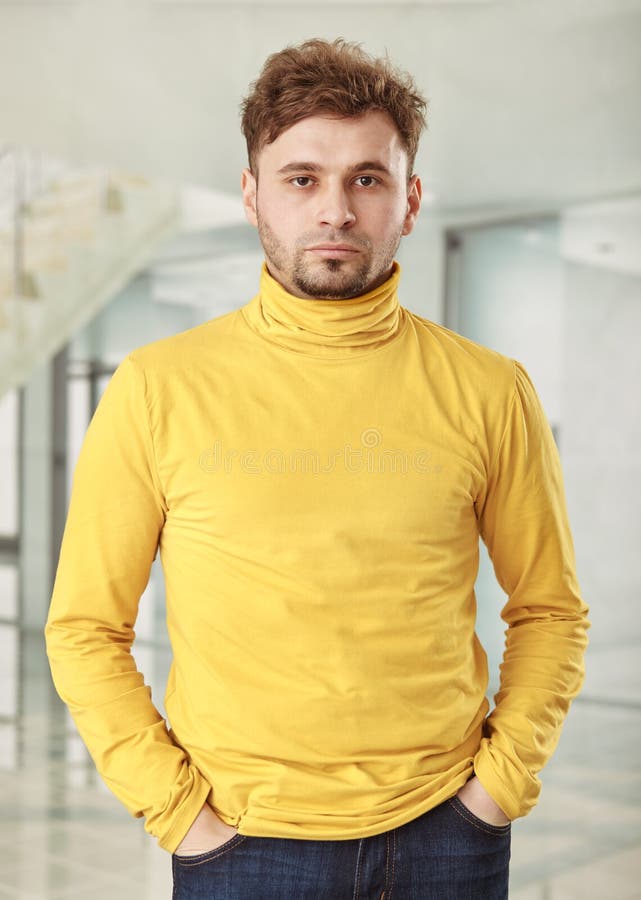 A Portrait of Young Business Man in Yellow Golf in Office Stock Photo ...