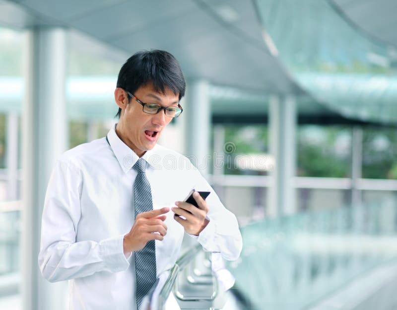 Portrait of Young Businessman Looking Scared with Smartphone. Stock ...