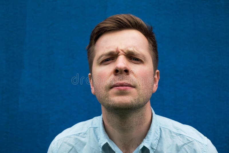 Portrait of Young Caucasian Man Looking Perplexed in Camera. Stock ...