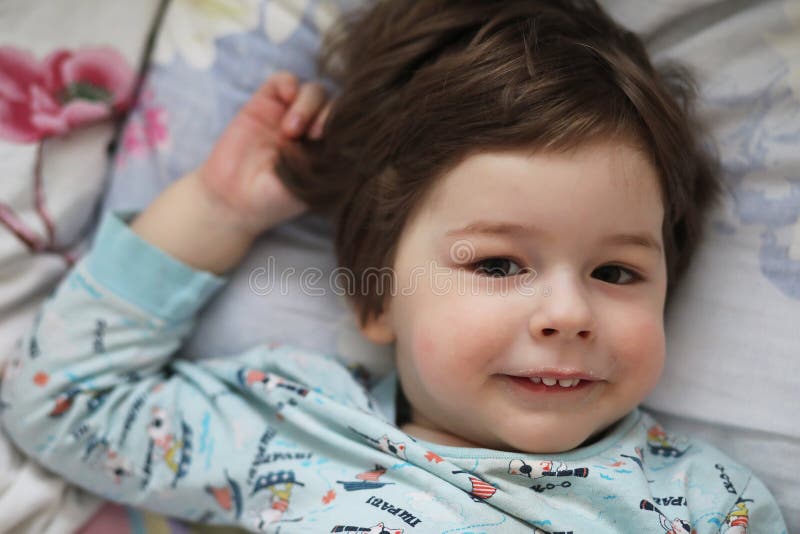 Portrait of a Young Child Lying on a Pillow Stock Photo - Image of ...