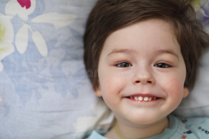 Portrait of a Young Child Lying on a Pillow Stock Image - Image of ...