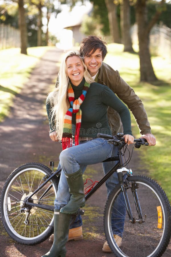 Portrait of Young Couple with Cycle in Autumn Park Stock Image - Image ...