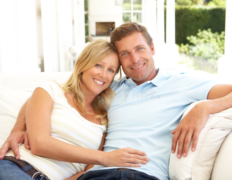 Portrait of Young Couple Relaxing Together on Sofa Stock Photo - Image ...