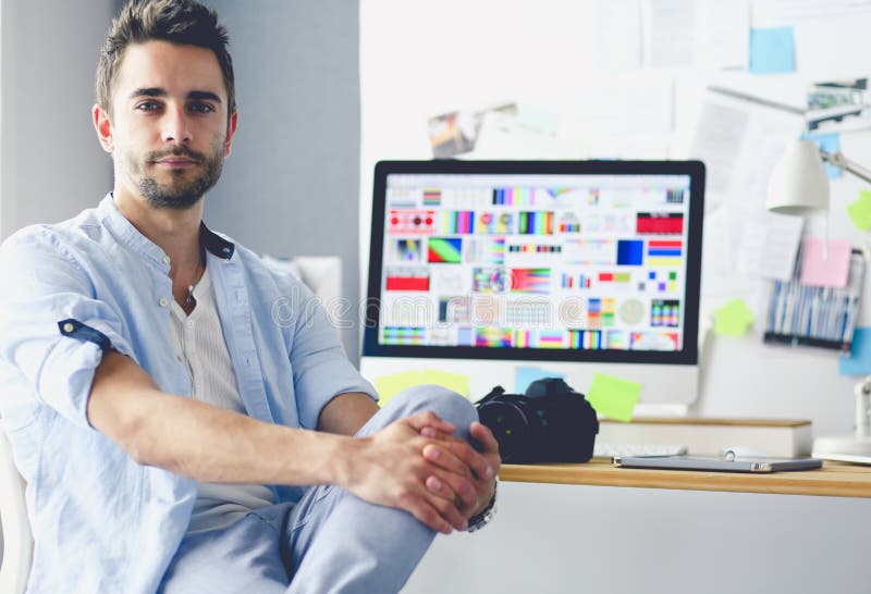 Portrait of Young Designer Sitting at Graphic Studio in Front of Laptop ...