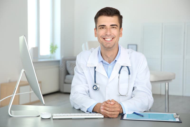 Portrait of Young Doctor at Table Stock Photo - Image of medicine ...