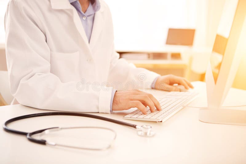 Portrait of a Young Doctor at Work Stock Photo - Image of list, details ...